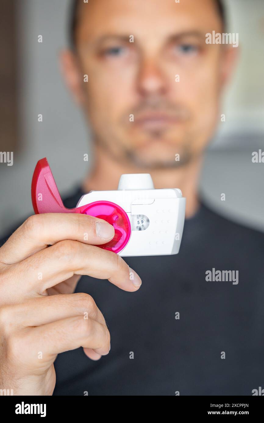 Close up view of man using medicine dry powder inhaler for treatment ...