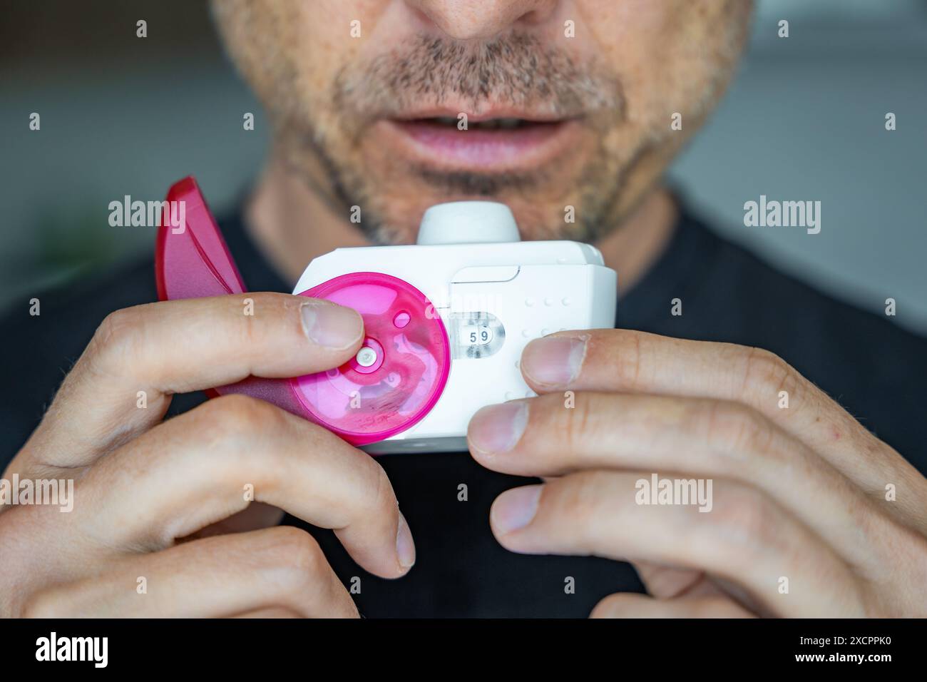 Close up view of man using medicine dry powder inhaler for treatment ...