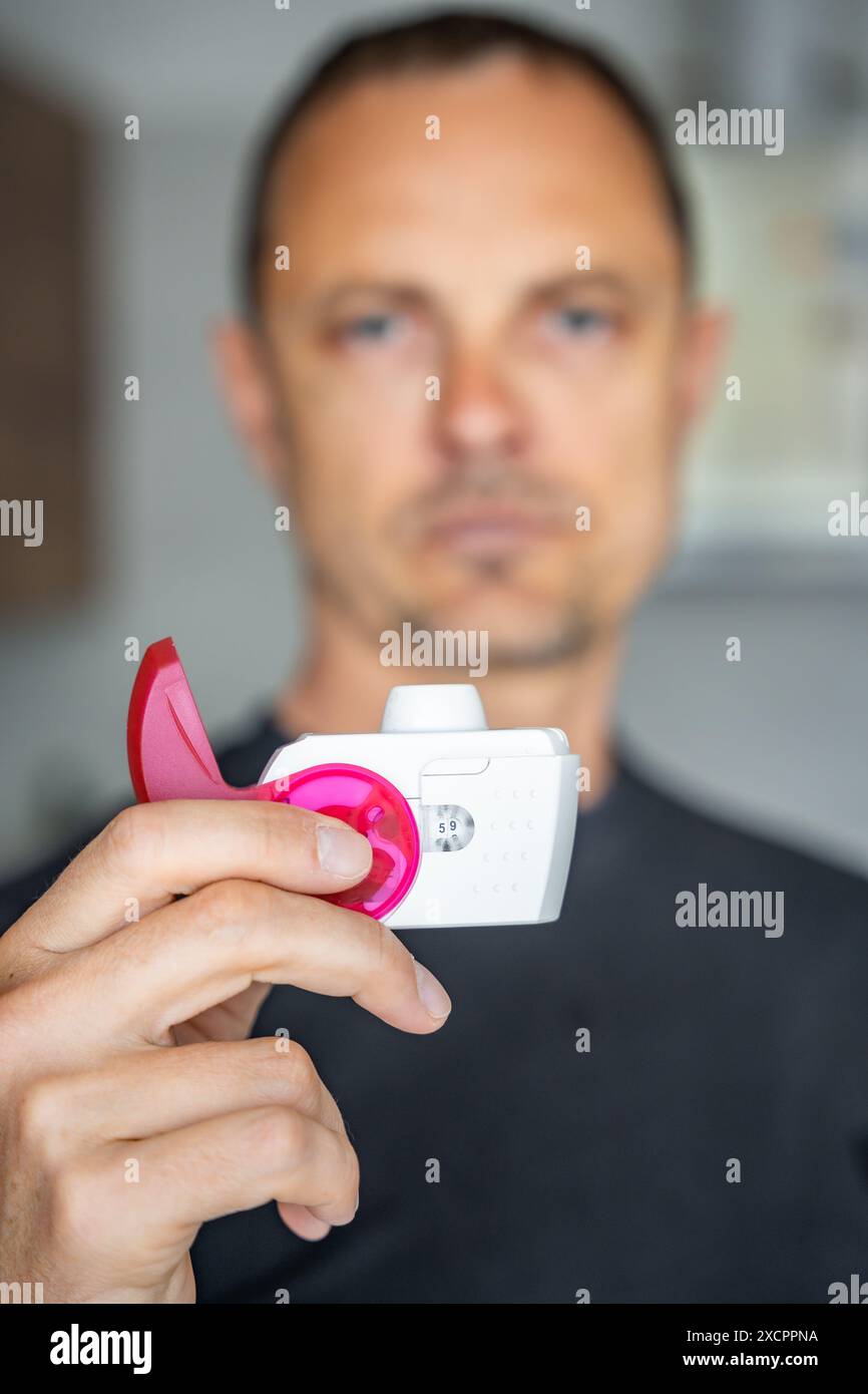 Close up view of man using medicine dry powder inhaler for treatment ...