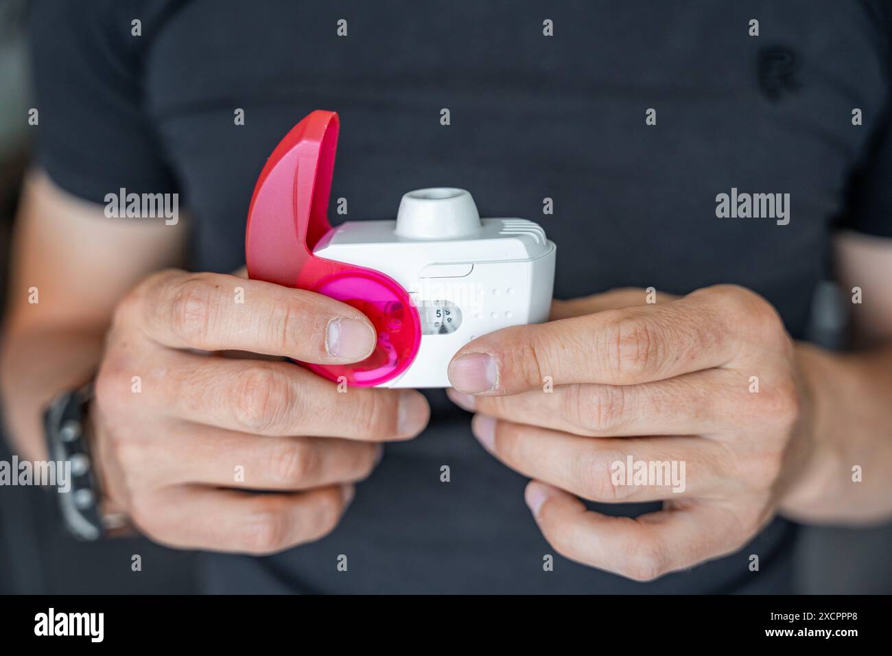 Close up view of man using medicine dry powder inhaler for treatment ...