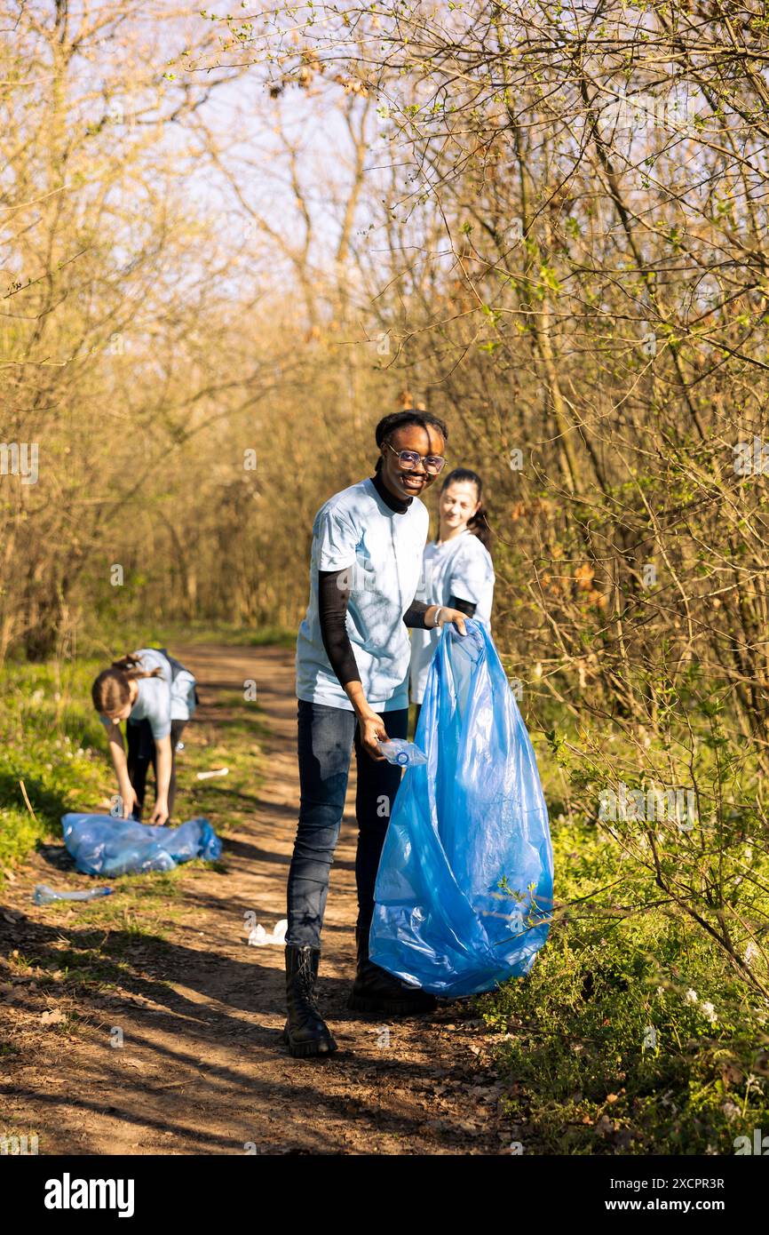 Volunteers collecting garbage in woods hi-res stock photography and ...