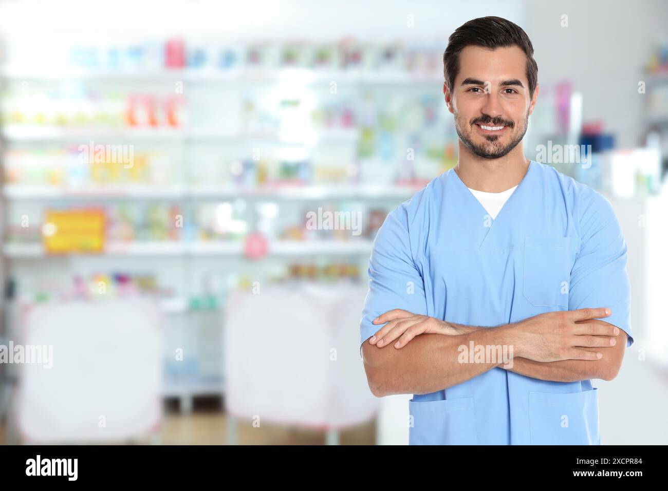 Positive pharmacist in uniform at drugstore. Space for text Stock Photo ...