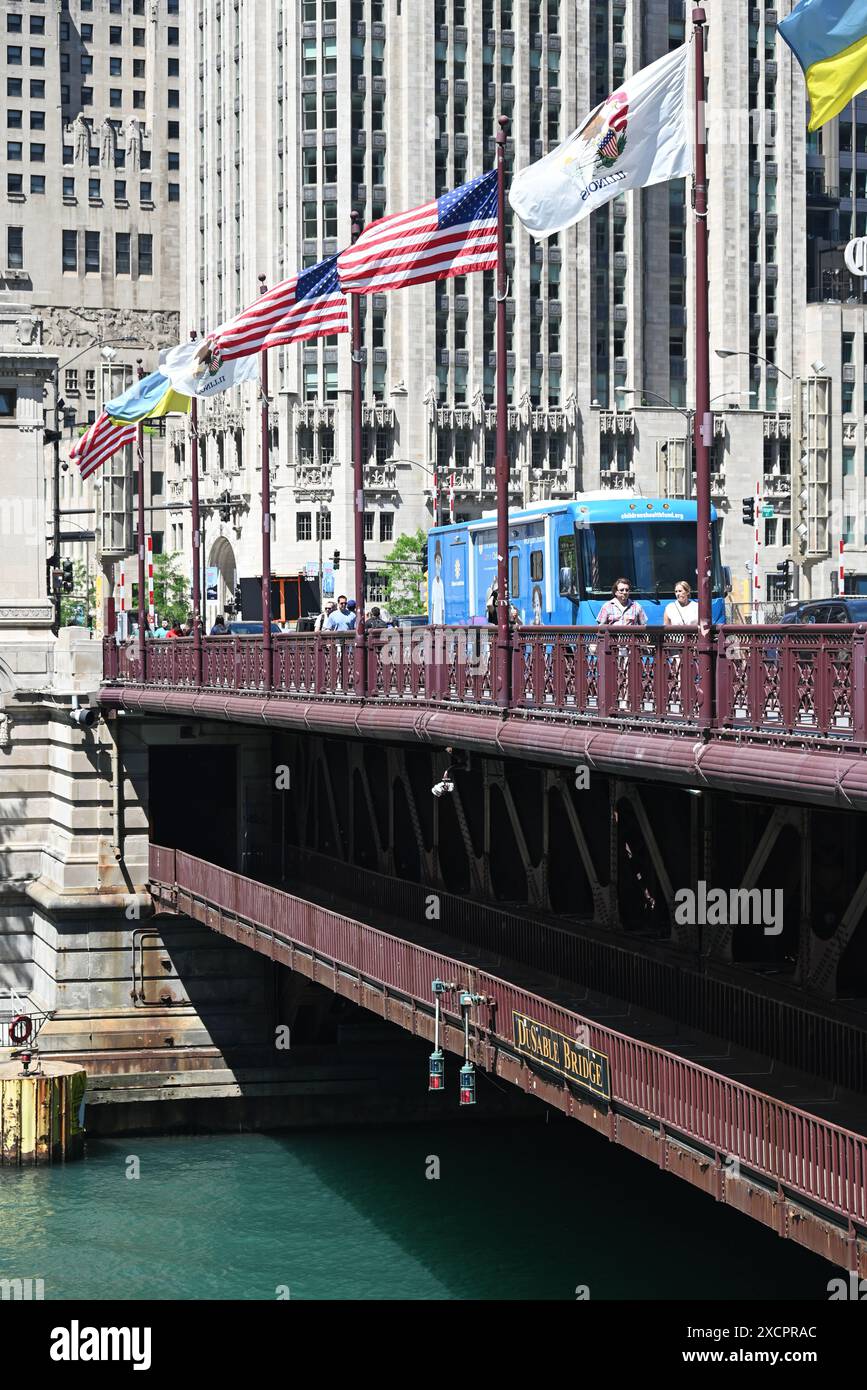 Flags blow in the wind along the DuSable bridge where Michgan Avenue ...