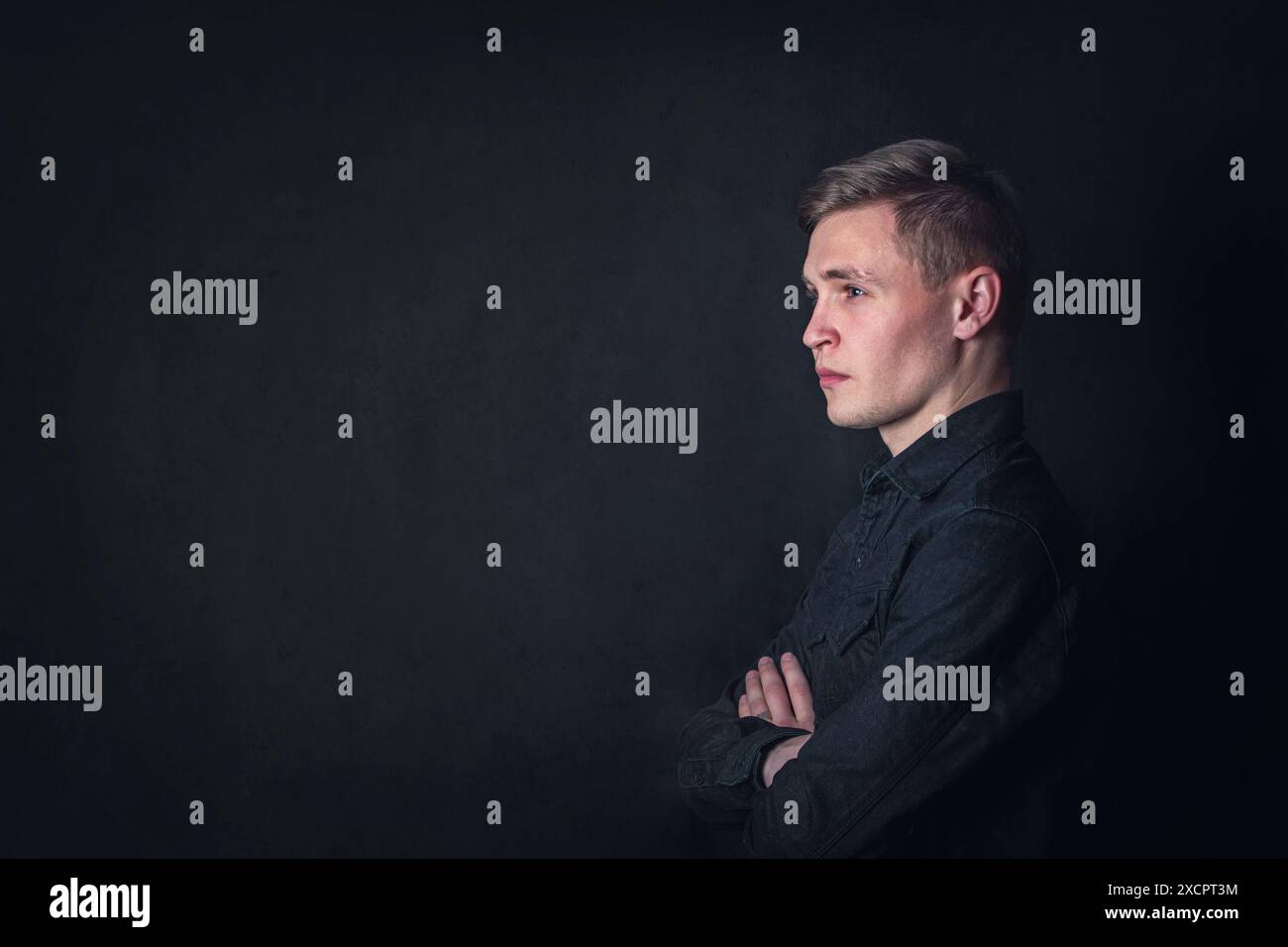 Serious contemplative young man side view portrait, looks pensive ...