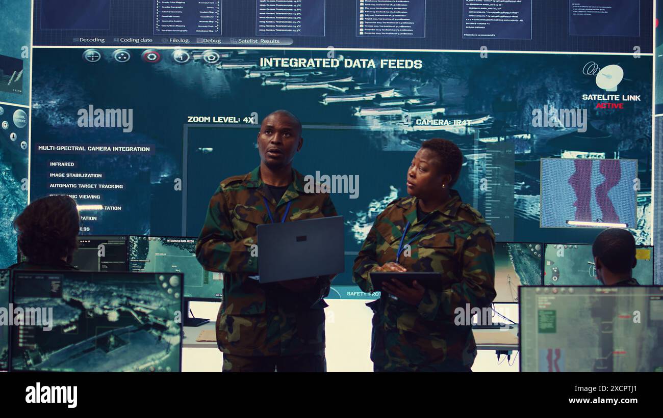Sergeant major and female soldier checking real time field data in ...