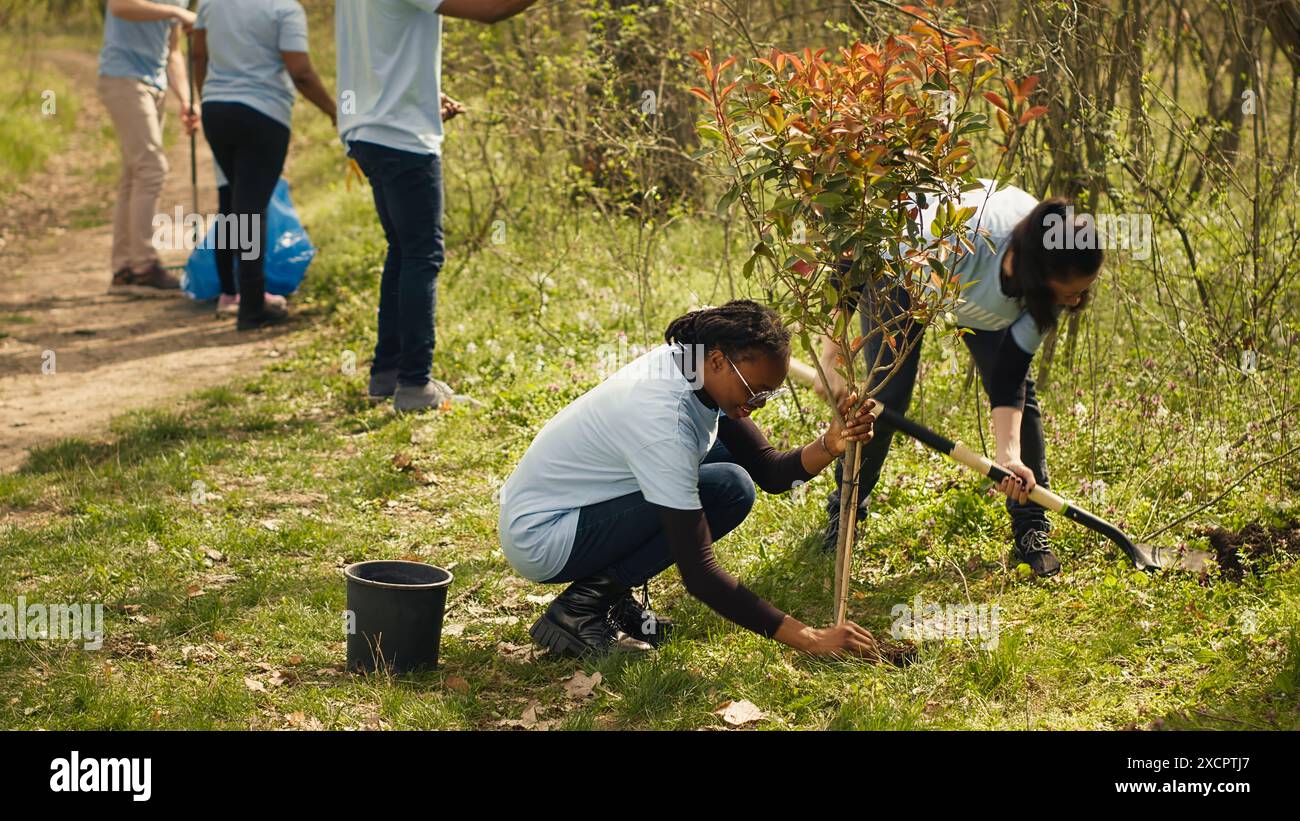 Team of climate change activists doing voluntary work to plant trees ...