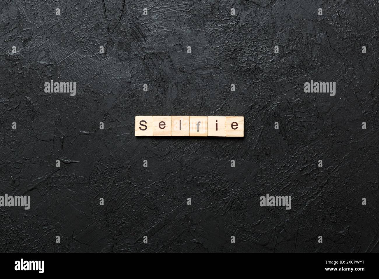 selfie word written on wood block. selfie text on cement table for your ...