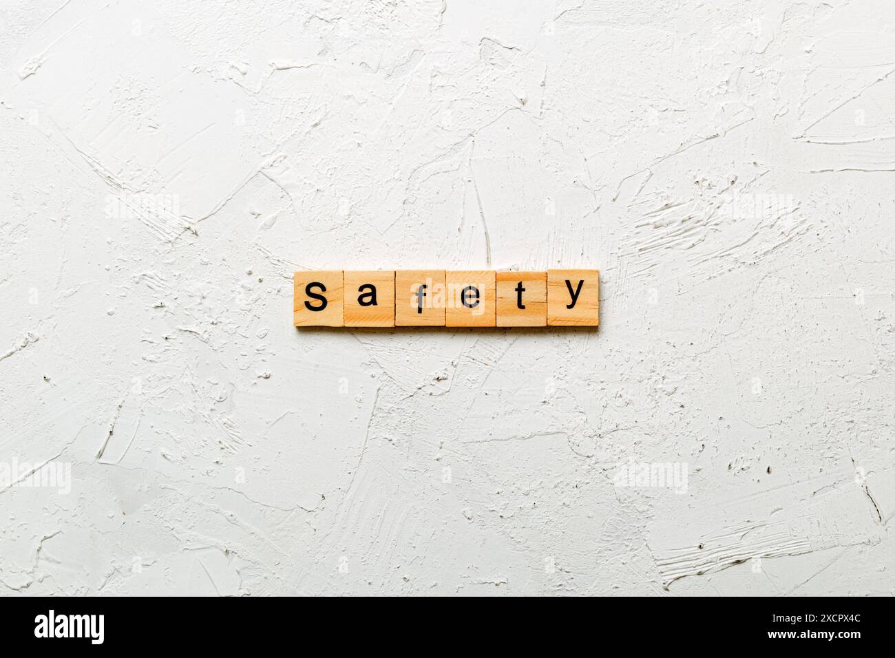 safety word written on wood block. safety text on cement table for your ...
