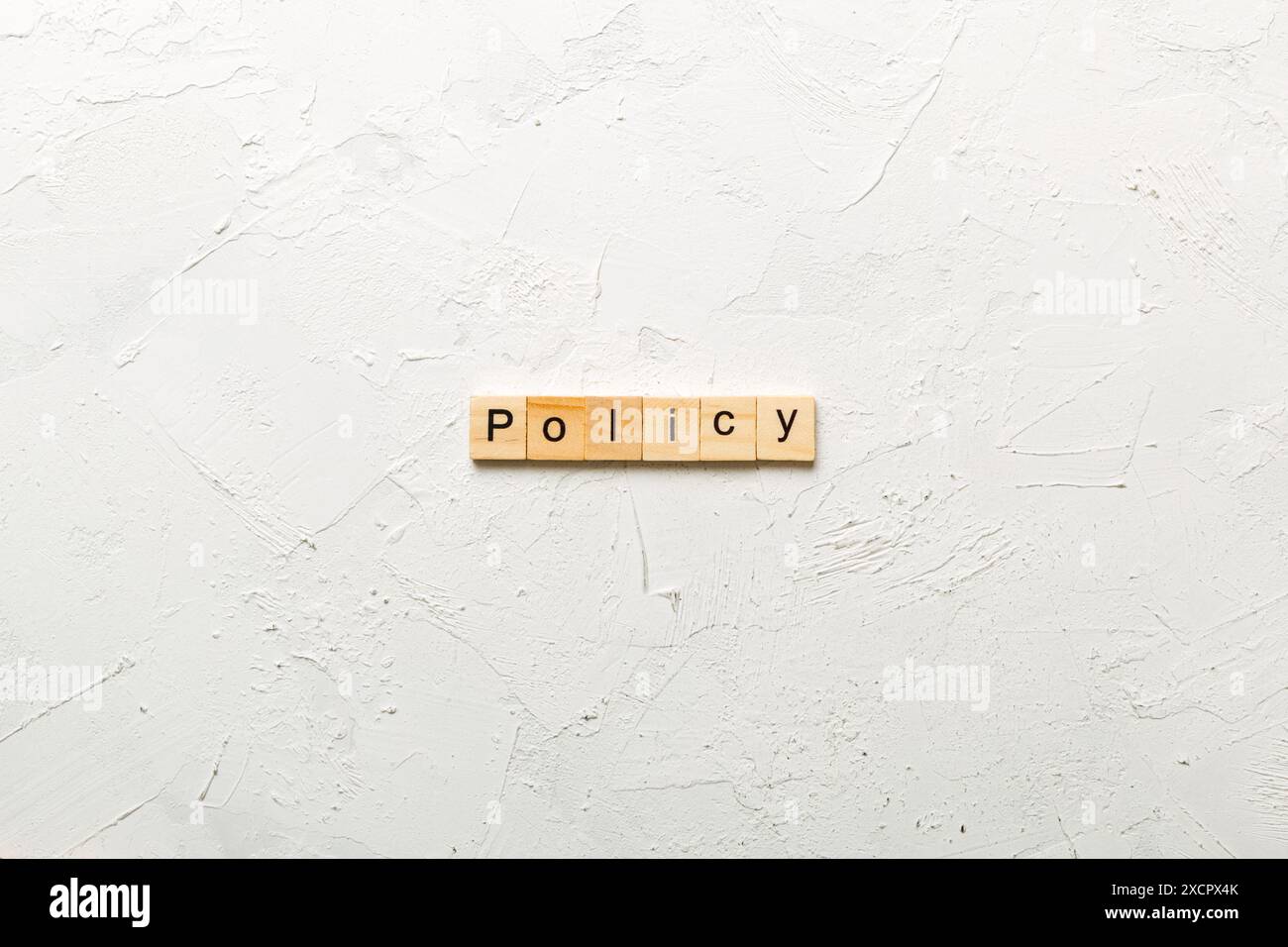 Policy word written on wood block. Policy text on cement table for your ...