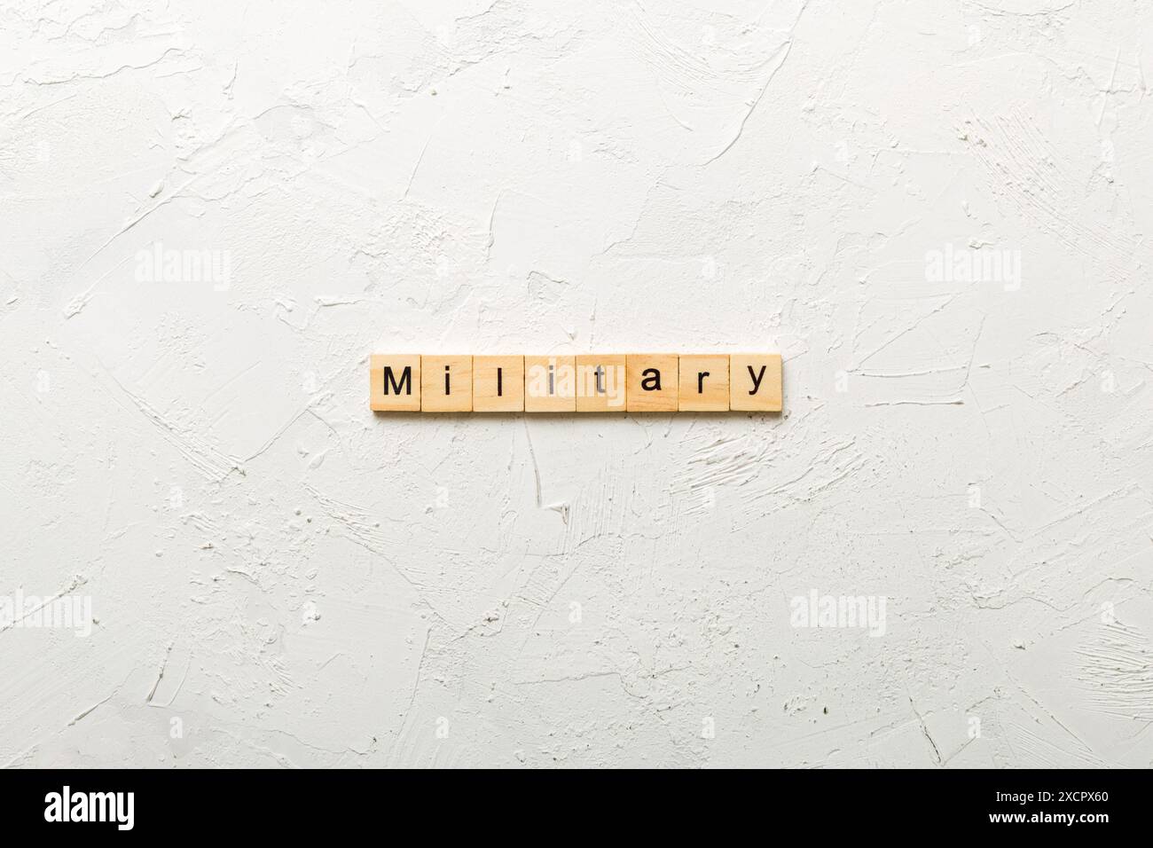 MILITARY word written on wood block. MILITARY text on cement table for ...