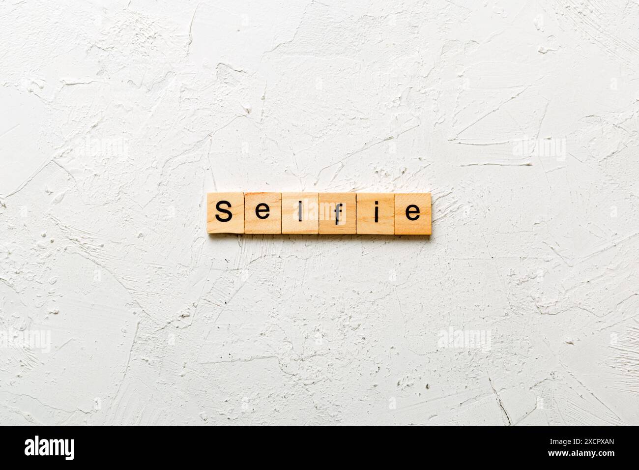 selfie word written on wood block. selfie text on cement table for your ...