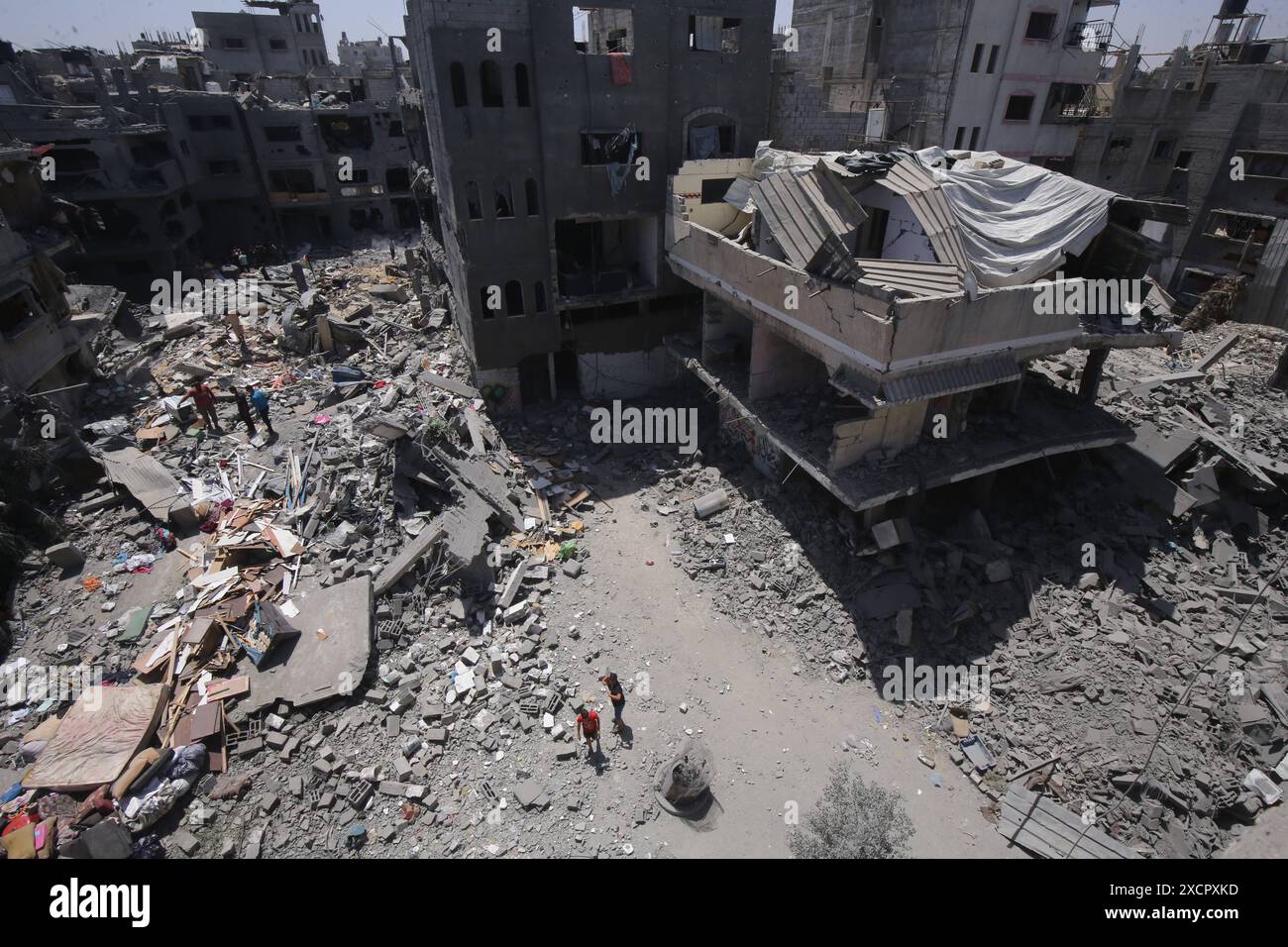 Palestinians search the rubble of the Harb family home which was hit in ...