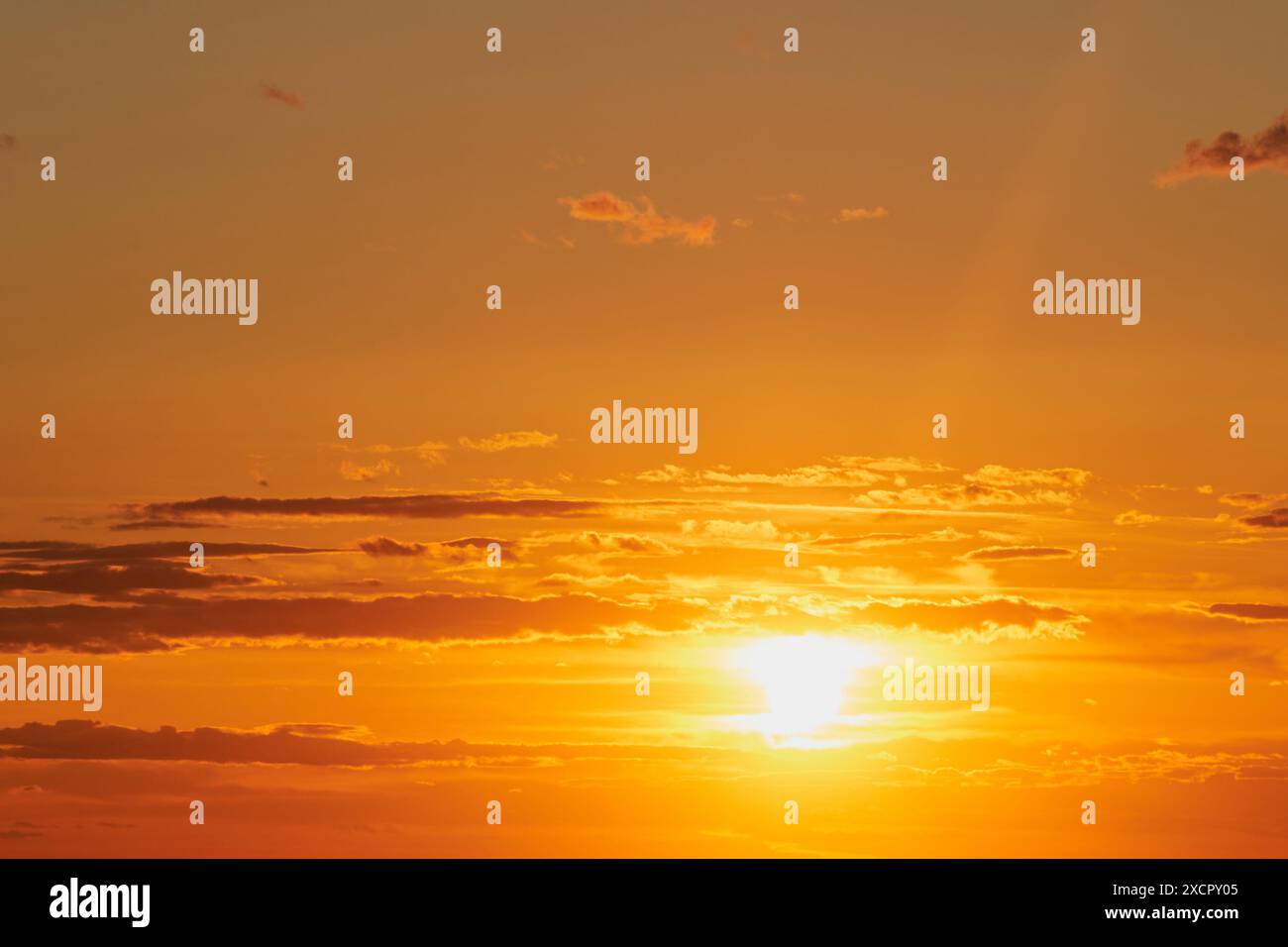 A sunset reveals the changing colors of the sky, from bright orange to ...