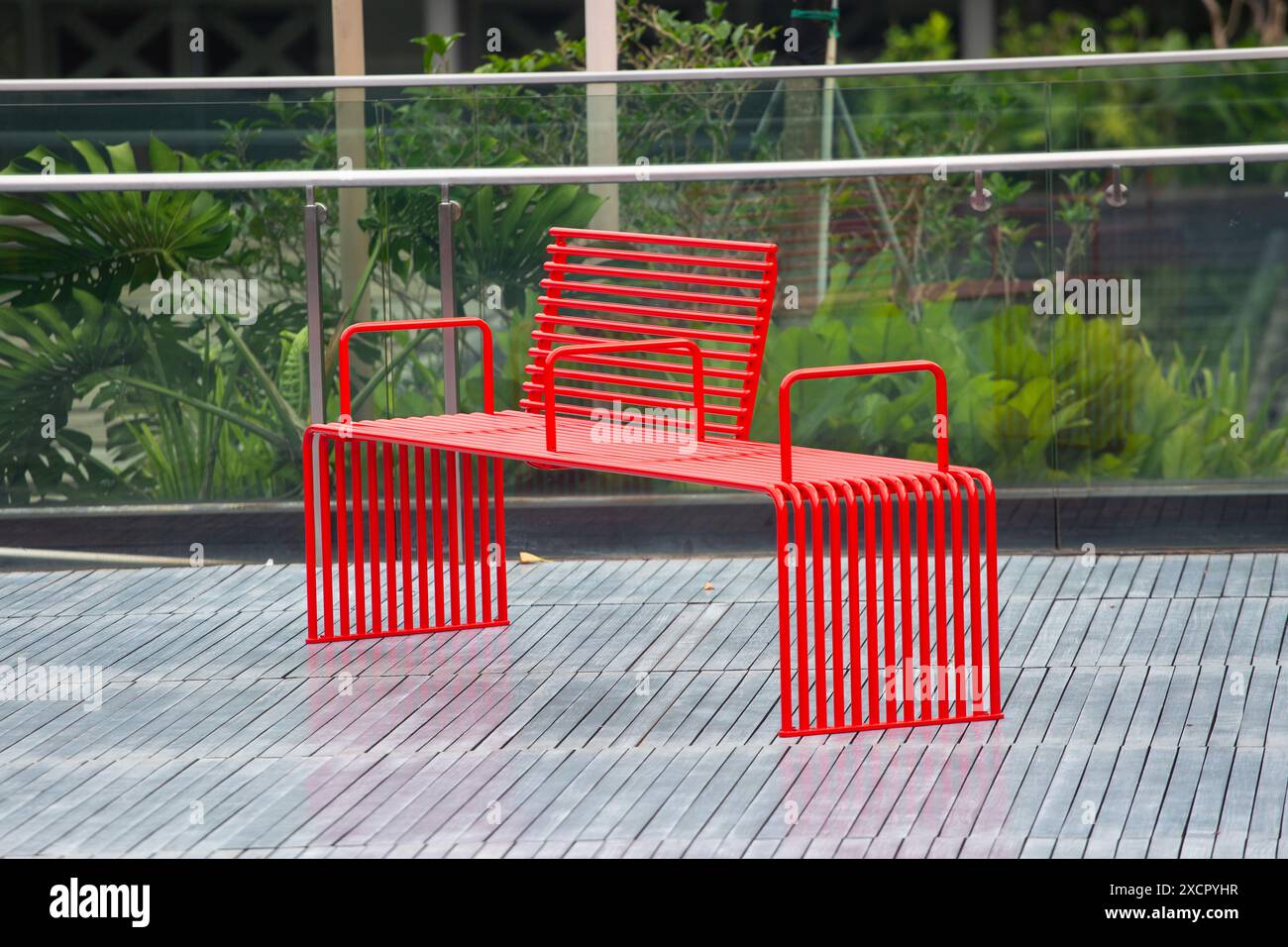 Eye catching red colour long bench with a back support design Stock ...