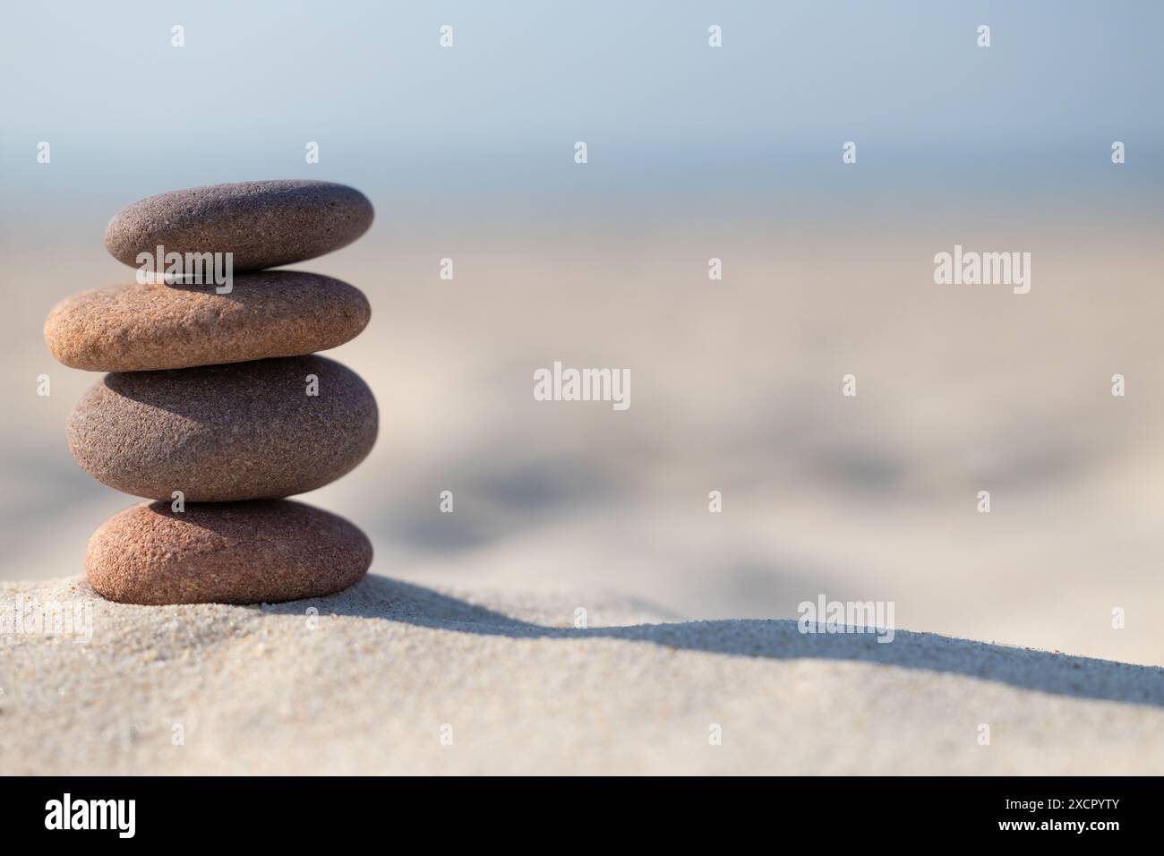 Stacked Pebbles on Sandy Beach Stock Photo - Alamy