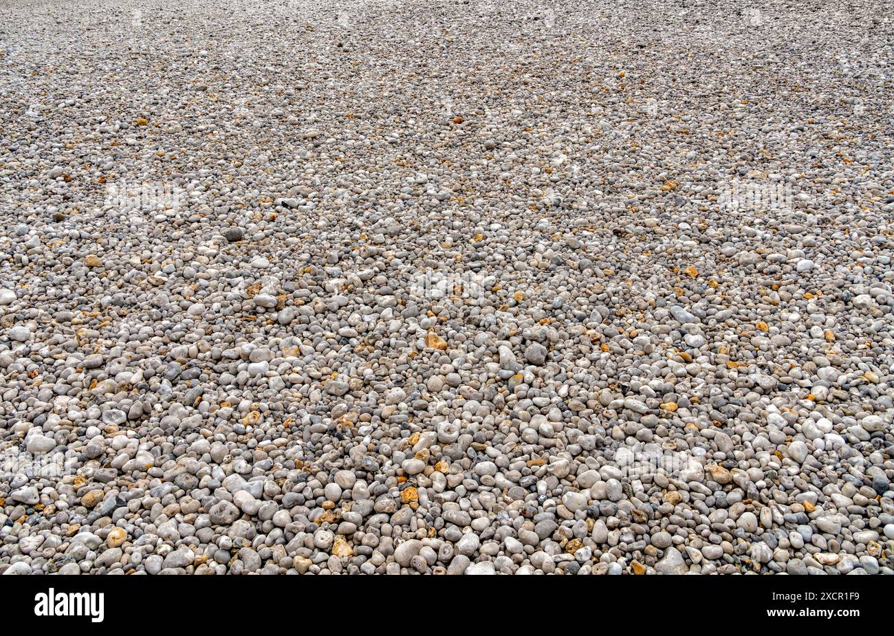Closeup coastal scenery showing lots of pebbles seen at a beach in the ...