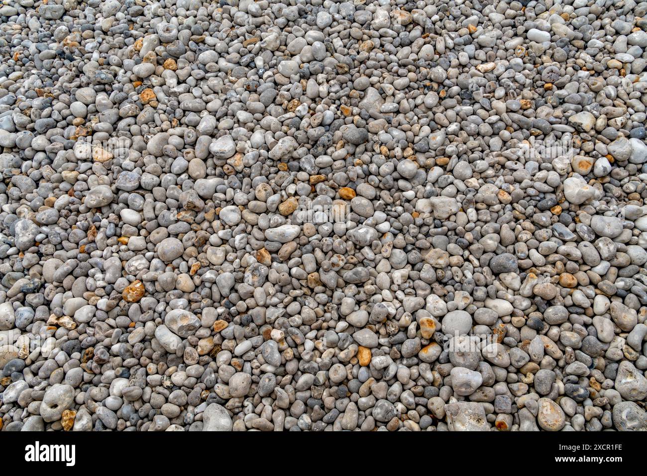 Closeup coastal scenery showing lots of pebbles seen at a beach in the ...
