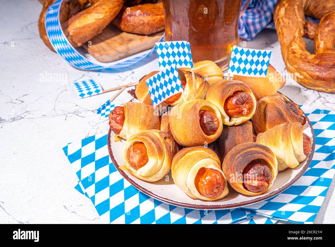 Oktoberfest party food. Pretzel hot dogs, puff pastry rolls with ...