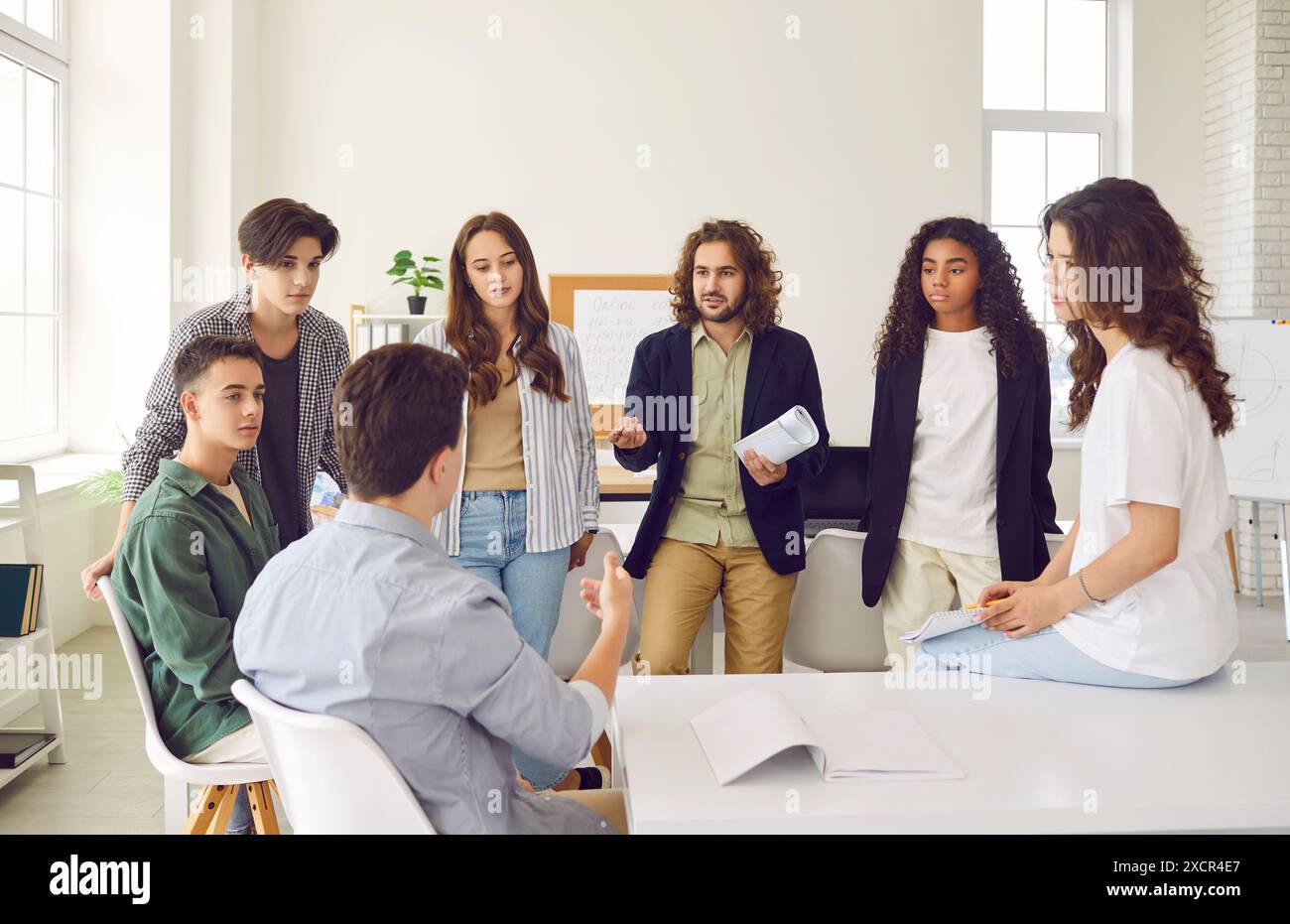 High school students sitting in a circle in the classroom and talking ...