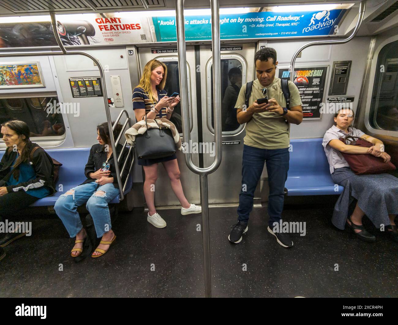 Distracted weekday riders in the subway in New York on Wednesday, June ...