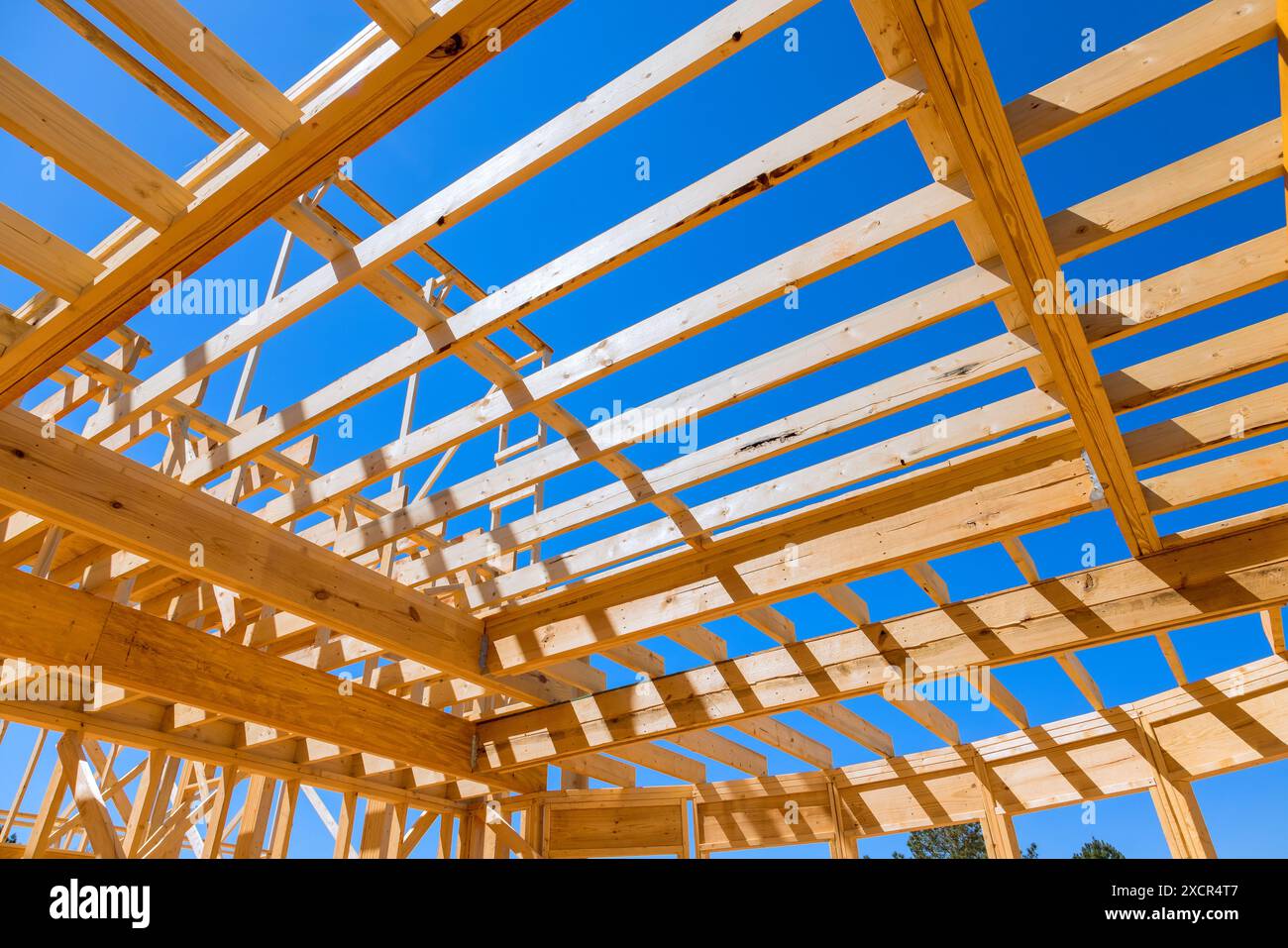 During construction of new home, ceiling roof trusses framework beams rafters were installed ...