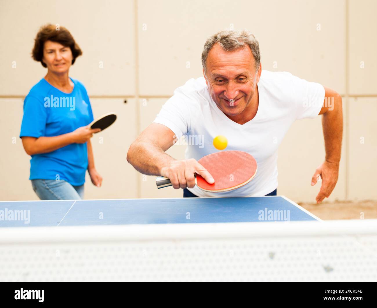 Mature couple playing ping pong outdoors at outdoor Stock Photo - Alamy