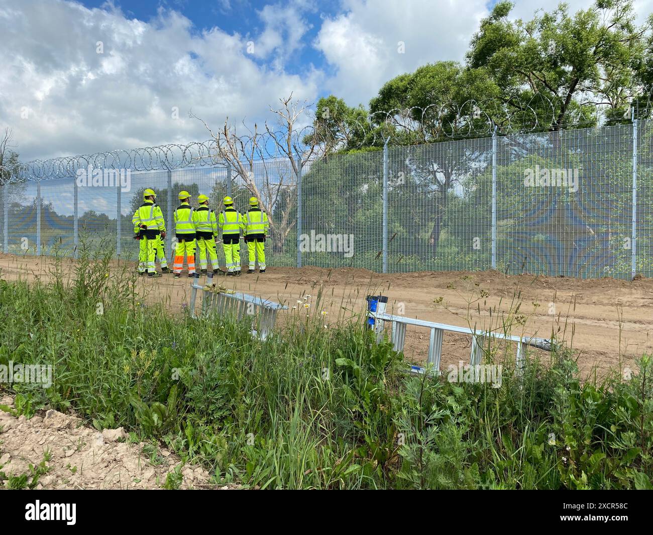 Karsava, Latvia. 18th June, 2024. Construction workers stand at the ...