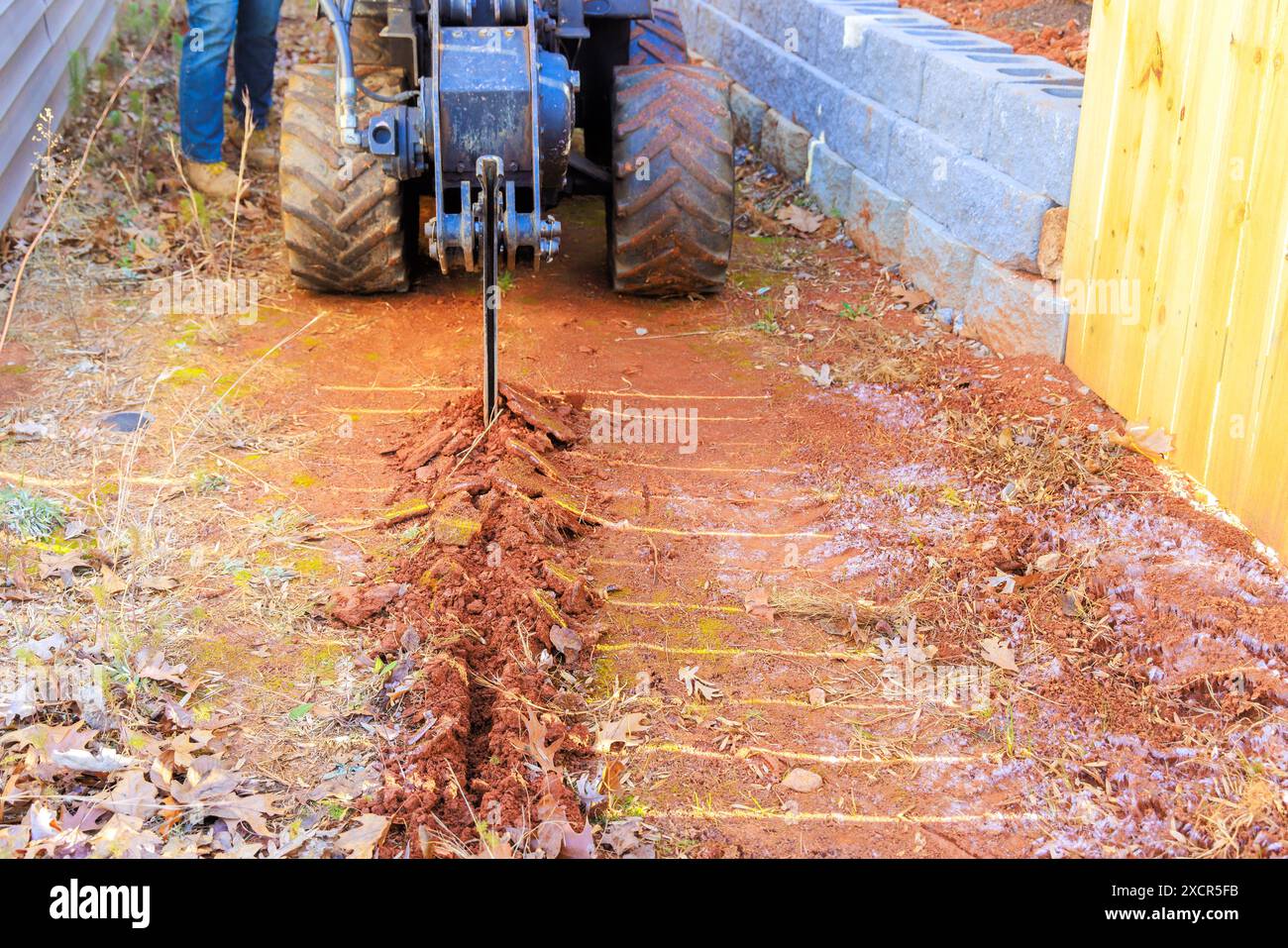 Tractor mounted trencher cable plows are used to lay fiber optic cables ...