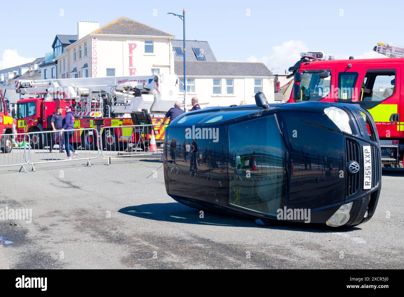 A car on its side is set for a demonstration of vehicle extraction team ...