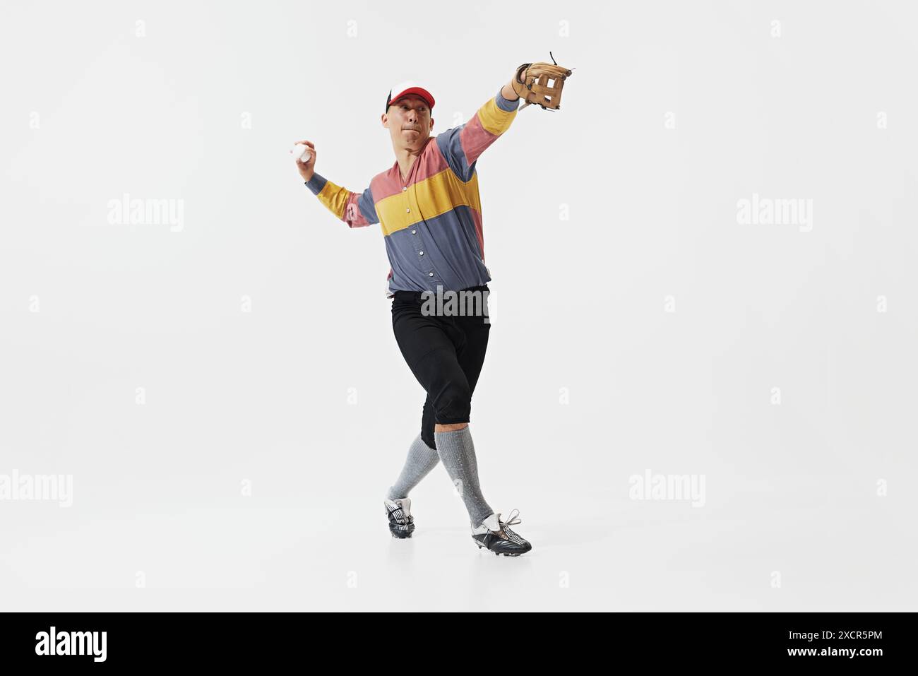 Full-length image of young guy, baseball player in serving ball ...