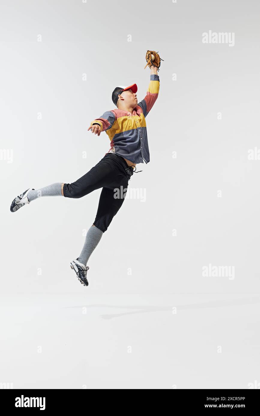 Full-length bottom view image of focused man, baseball player in motion ...