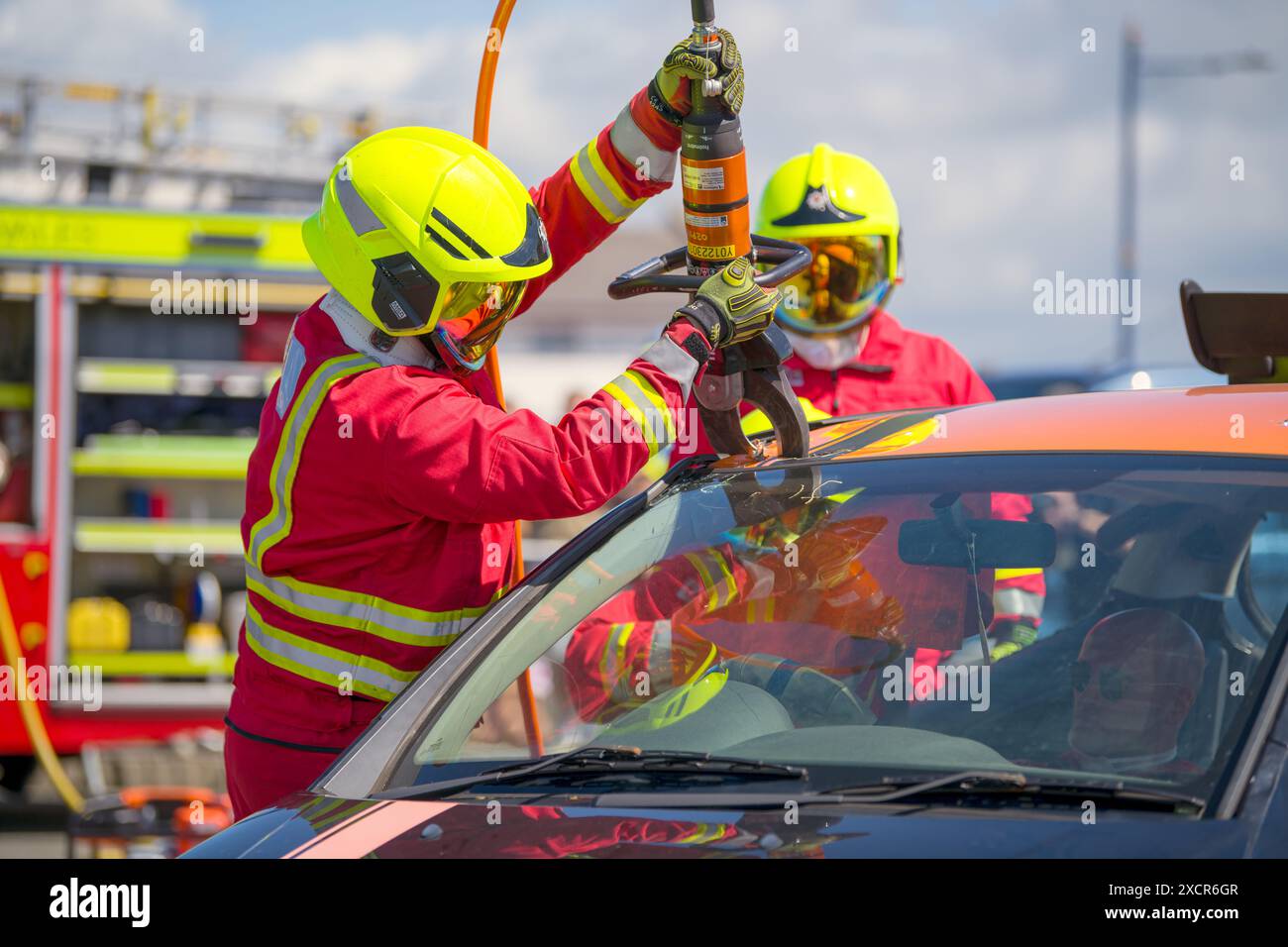 Fireman with a hydraulic cutter removes cuts off the roof at Rescue ...