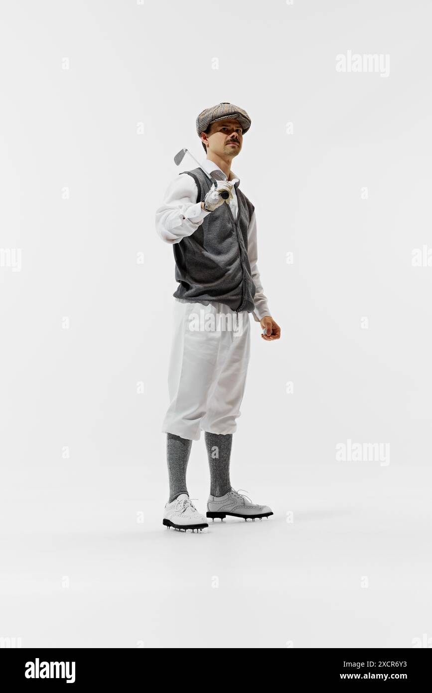 Spirit of vintage golf, this man poses with a golf club, showcasing a ...