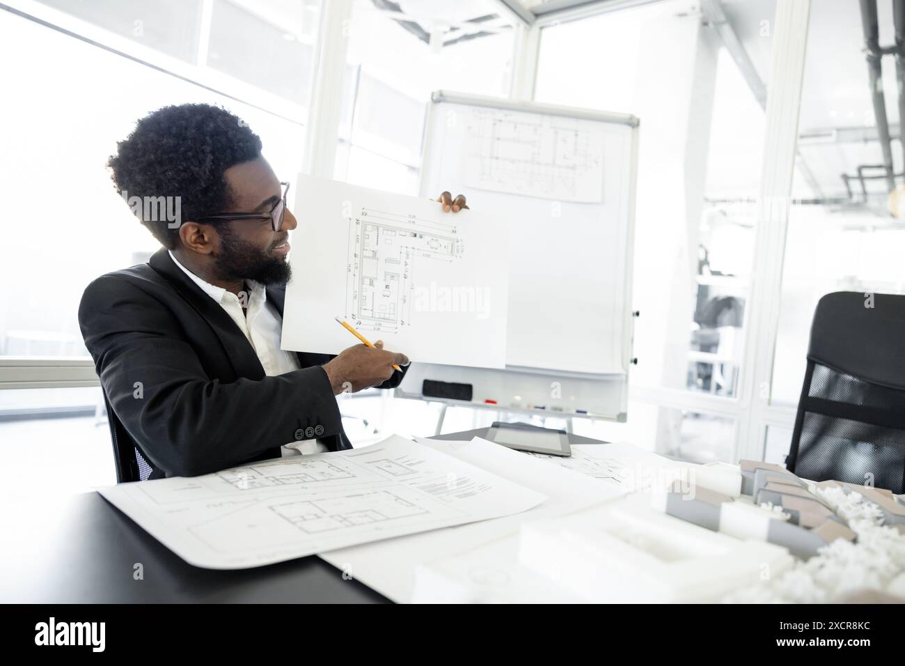 Successful man architect working on estate construction project in the ...