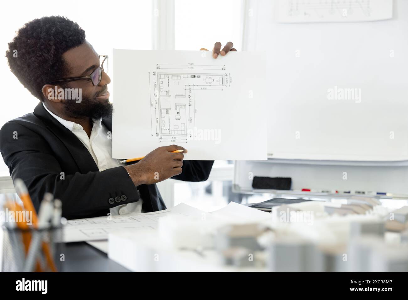 Innovative man architect presenting blueprints on presentation n his ...