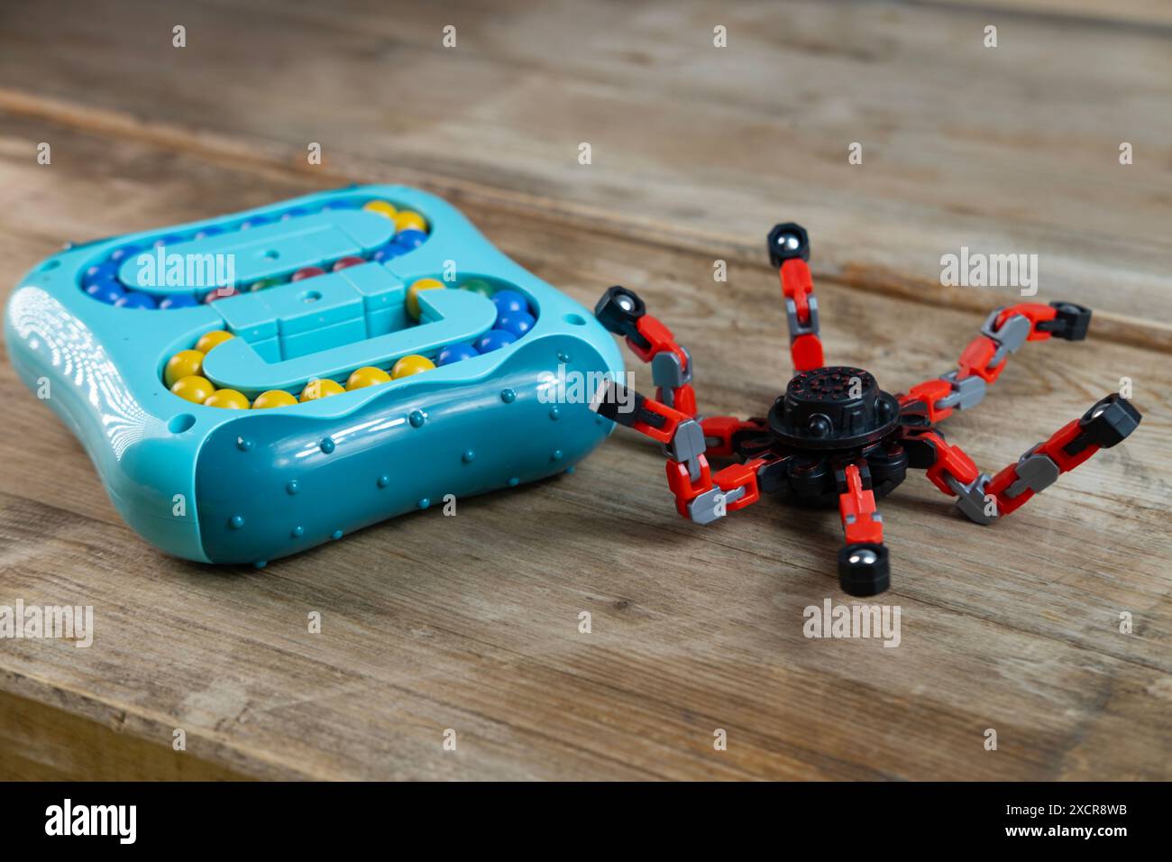Spinner, puzzle with balls, brain exercise on table, stress relief ...