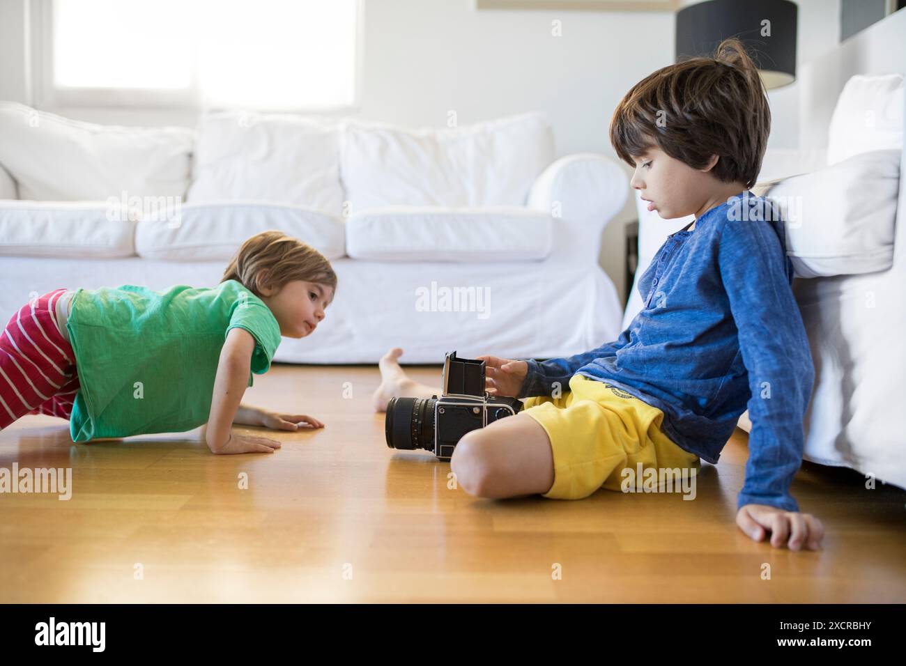 Two young brothers engage in playful interaction, with one brother ...