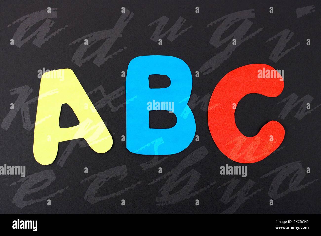 ABC, colorful letters highlighted on a black background that simulates ...