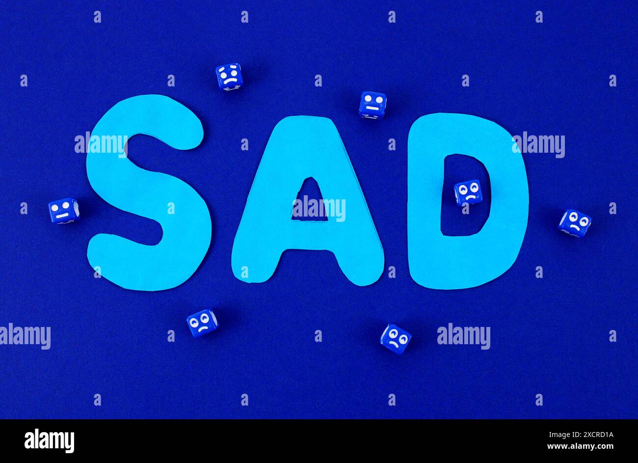 Cubes with sad expression around word that describes the same mood ...