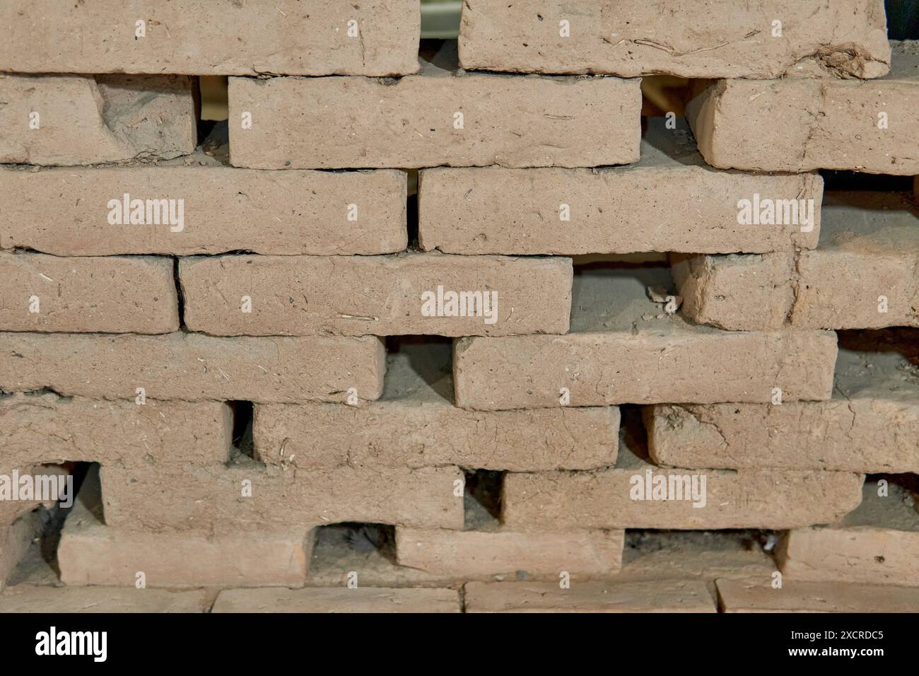 wall of mud bricks leaning against each other one on top of the other ...