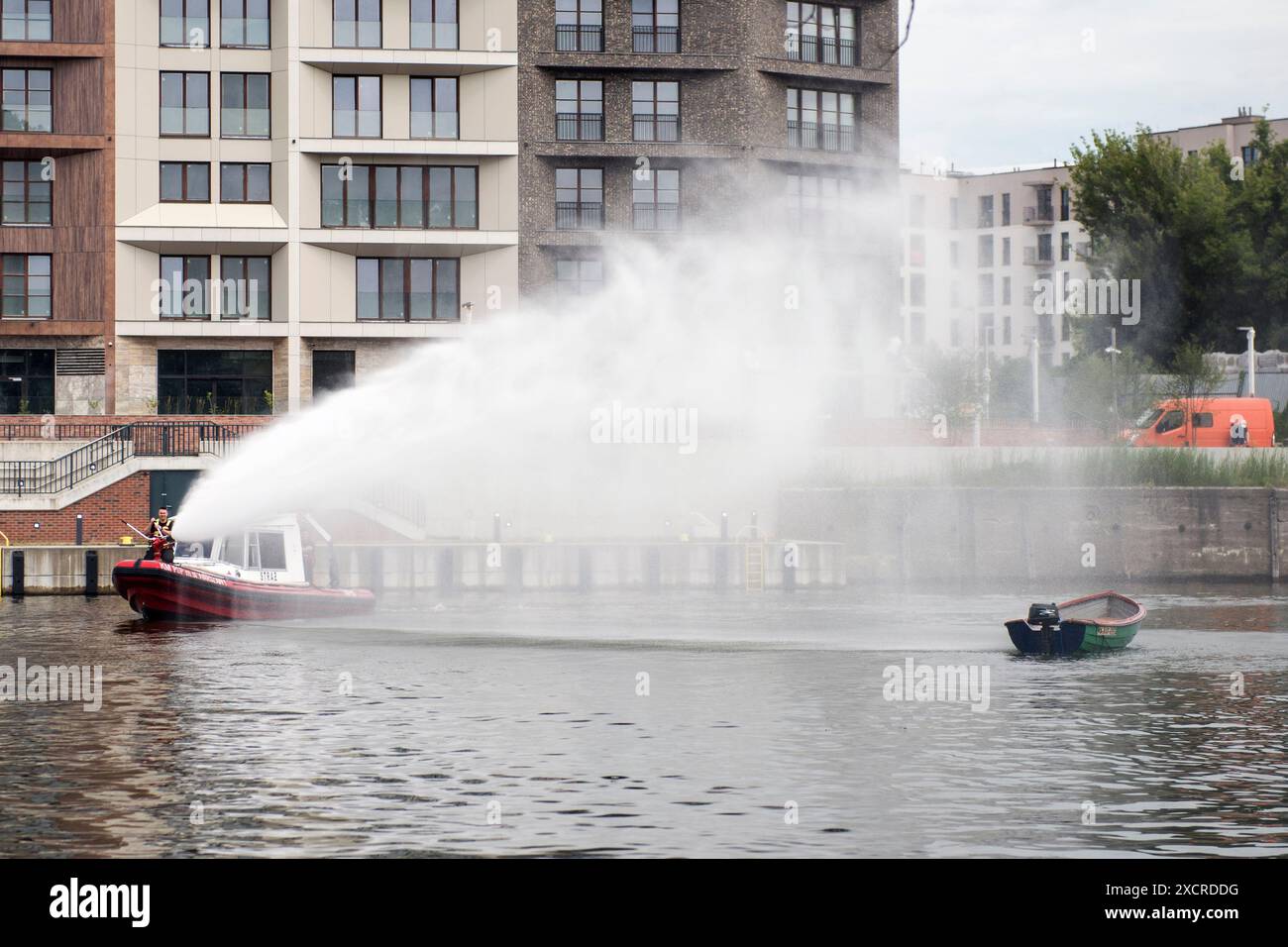 A fire brigade boat seen extinguishing at a burning boat during a water ...