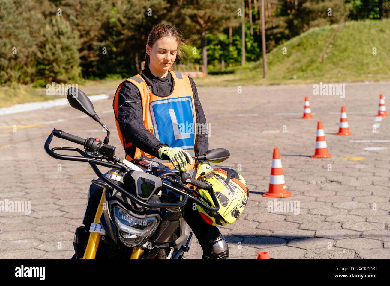 Learning to ride motorcycle concept. motorcycle driving school. a woman ...