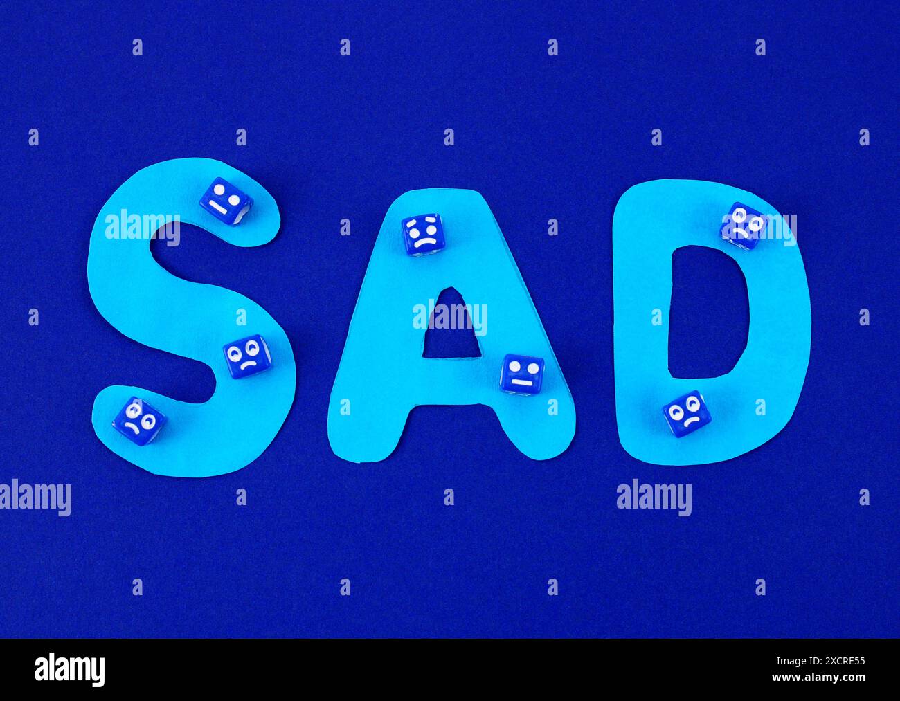 Cubes with sad expressions on word Stock Photo - Alamy