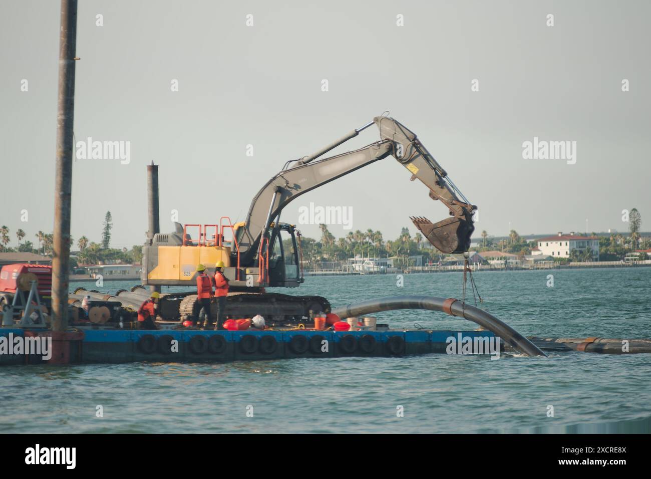 Medium Wide view of Looking out to Pass-a-grille channel. Dredge boat ...