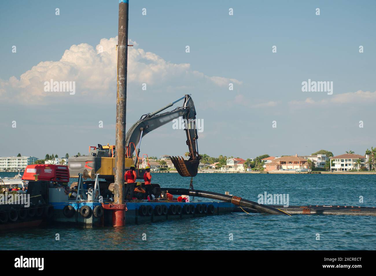 Medium Wide view of Looking out to Pass-a-grille channel. Dredge boat ...