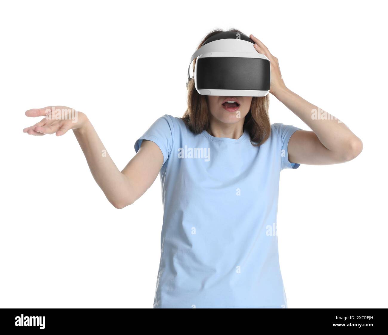 Emotional woman using virtual reality headset on white background Stock ...