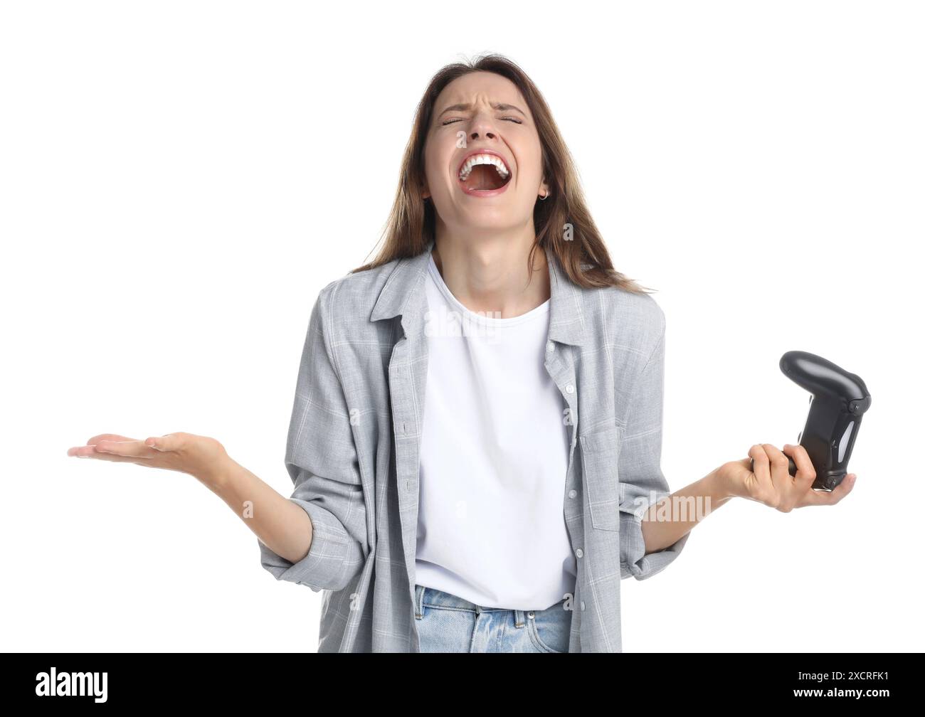 Emotional woman with game controller on white background Stock Photo ...