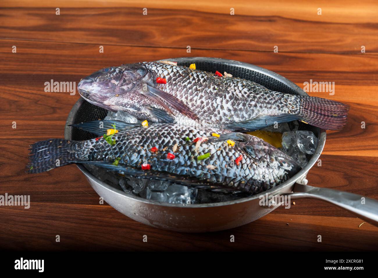 getting fish ready to be cooked in a saucepan Stock Photo - Alamy