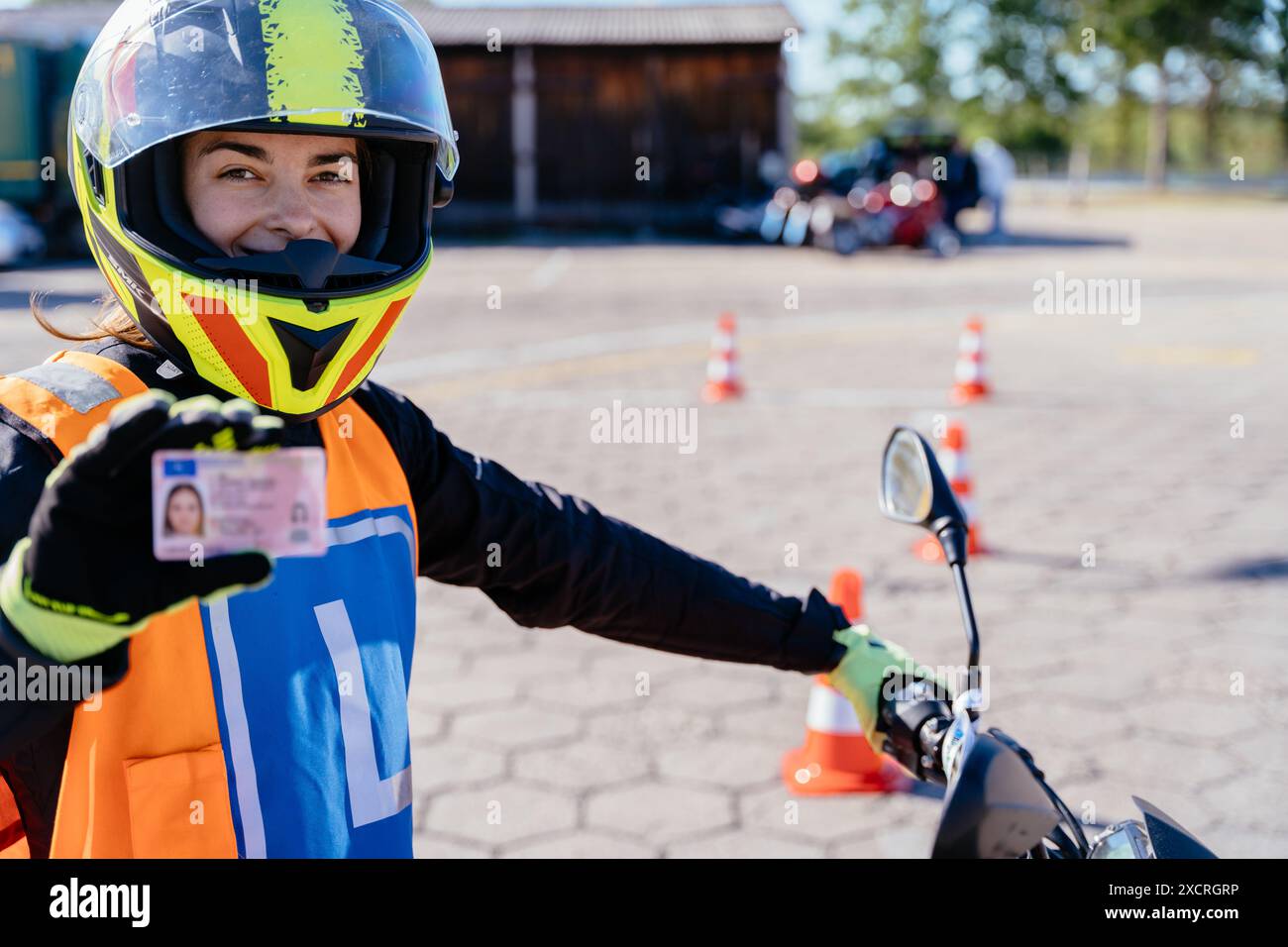 Student L driver showing motorcycle driving license as successfully ...