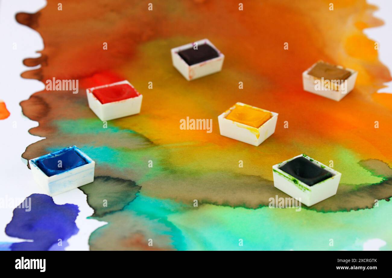 Solid watercolor tablets on background with color spots Stock Photo - Alamy